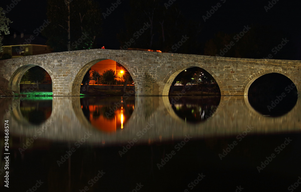 Old stone bridge and its reflection at night Stock Photo | Adobe Stock