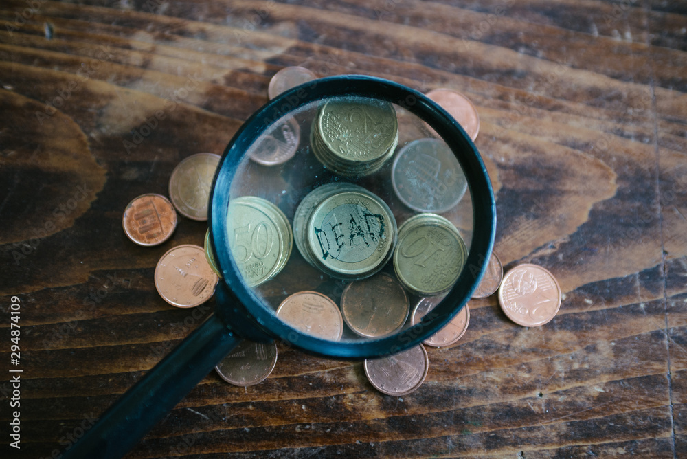 magnifying glass over a euro coin Stock Photo | Adobe Stock