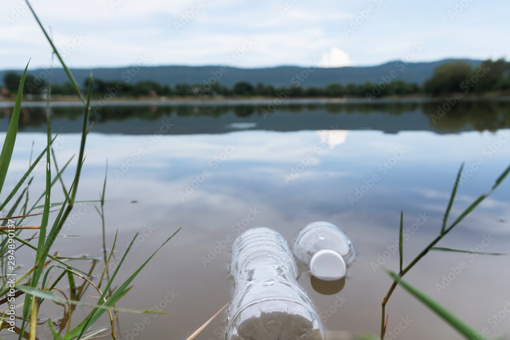 Plastic water bottles pollution in the river. Plastic trash in water ...