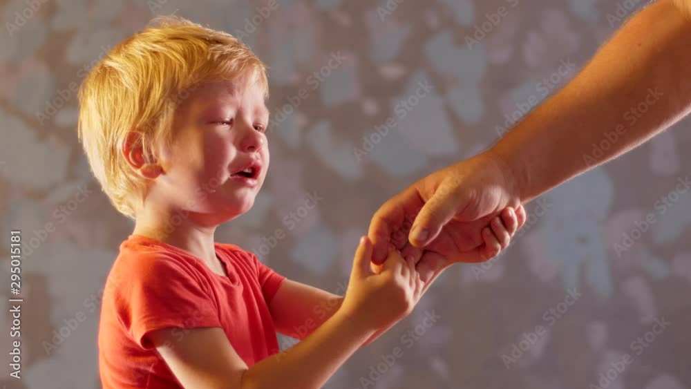 Father scolds child, shows tight fist and wants to punish him. Baby in ...
