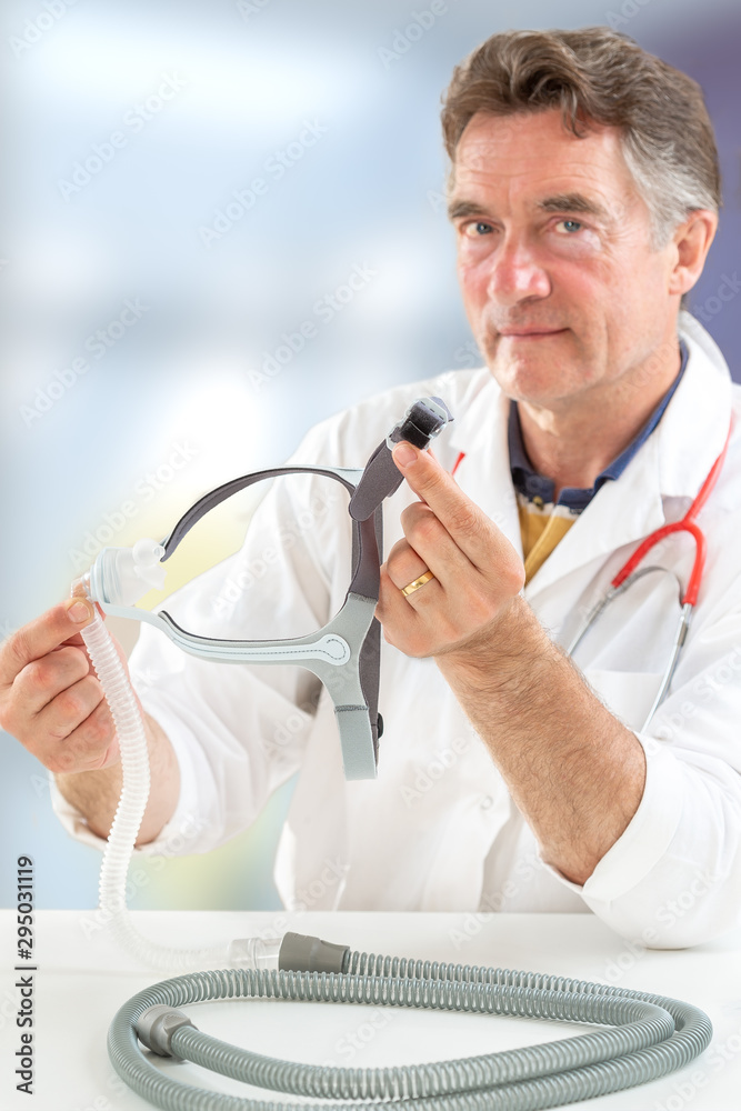 Doctor demonstrating Treatment of sleep apnea and snoring for patient ...