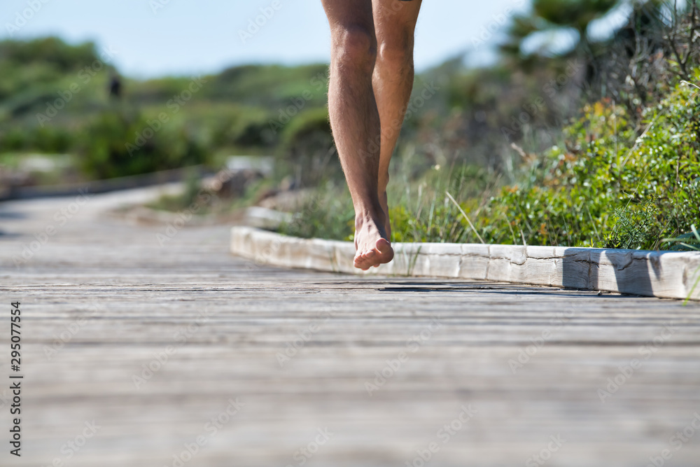 Legs of man jumping on sunny day barefoot with blur background. Stock ...