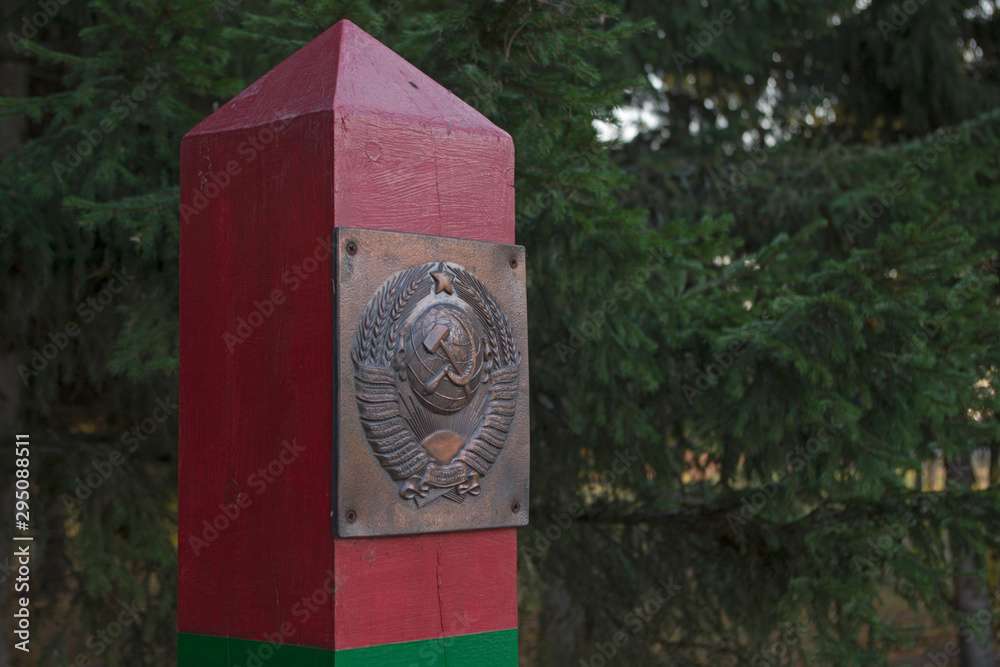The top of wooden border post painted in green and red horizontal ...