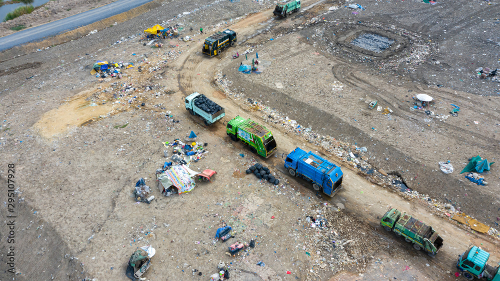 Garbage trucks unload garbage to open landfill, Surface and subsurface ...