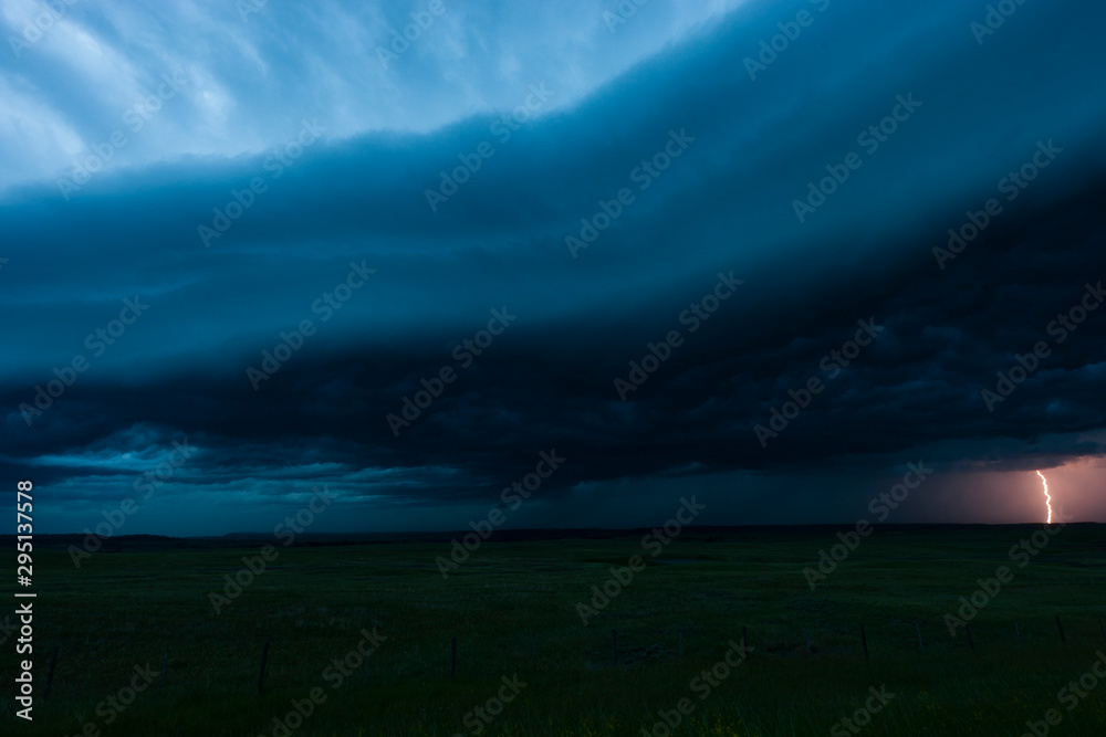 Giant blue supercell with bolt of lightning hitting the ground Stock ...