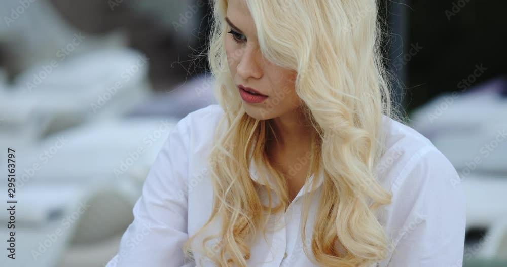 shocked at information lady with long loose curly fair hair types on ...