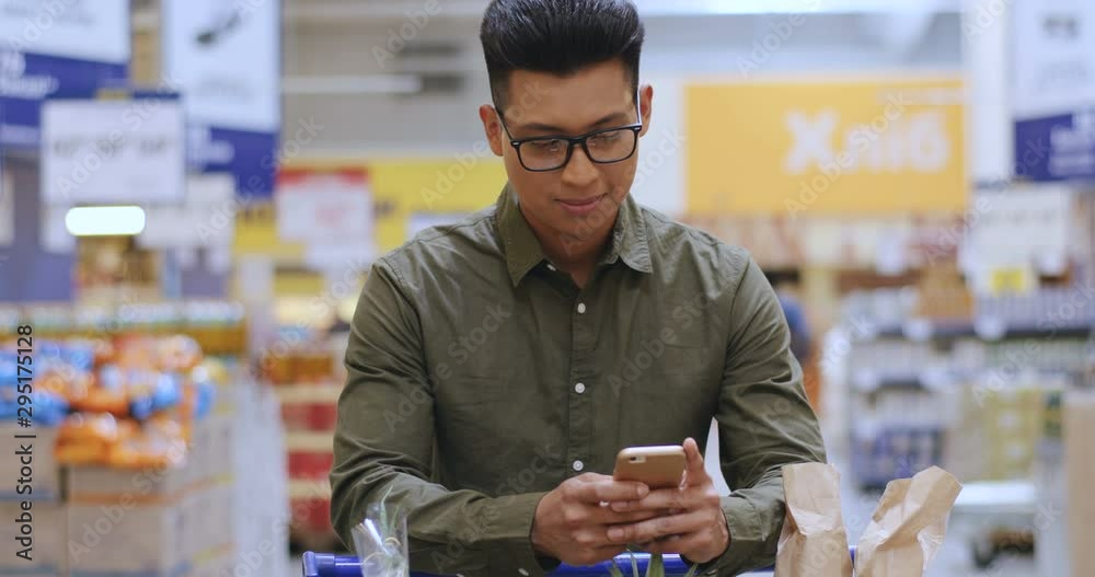 Asian young man tapping and typing while texting and chatting on the ...