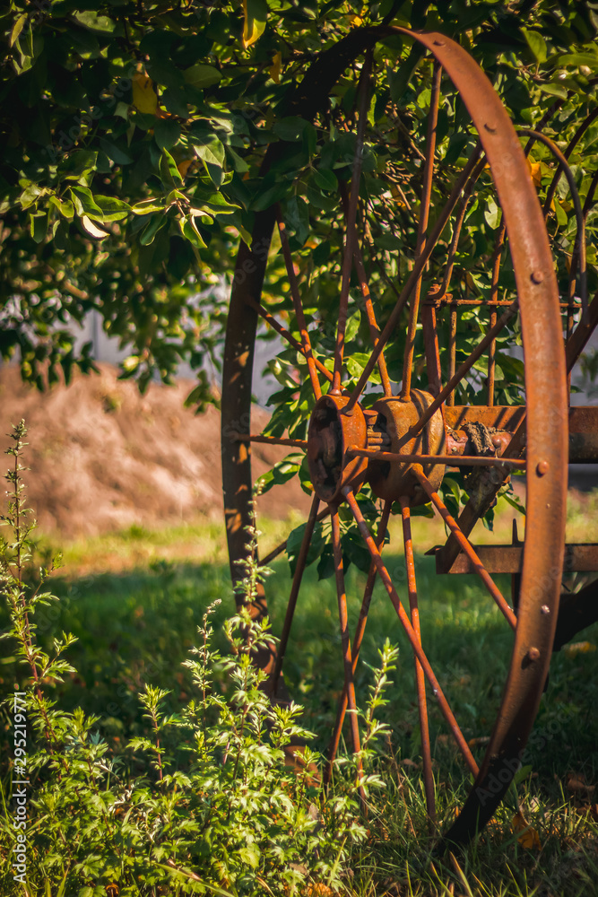 Old agricultural tool. Abandoned farming equipment. Rusty metal gear ...