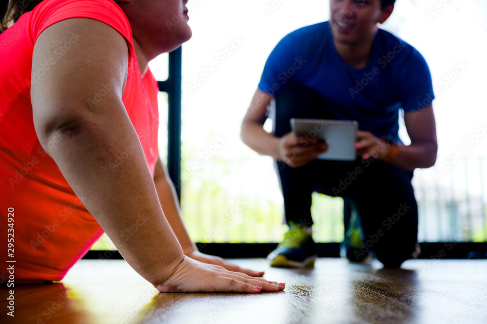 Foto de hand and arms of fat plump woman try to lift up body weight in ...