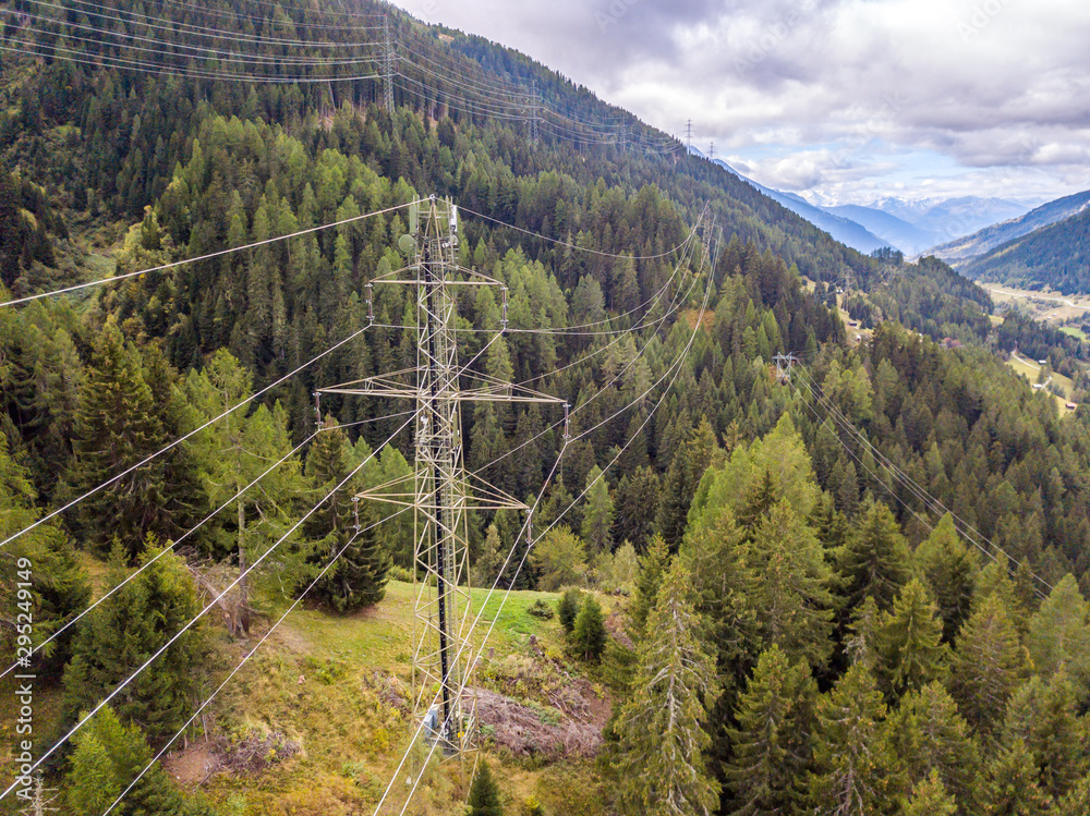 Aerial view of power line and pylon in alpine valley of Goms in ...