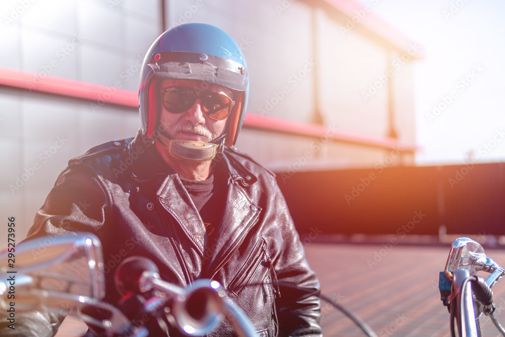 Soft light Portrait of a middle-aged man, an old biker in a leather ...