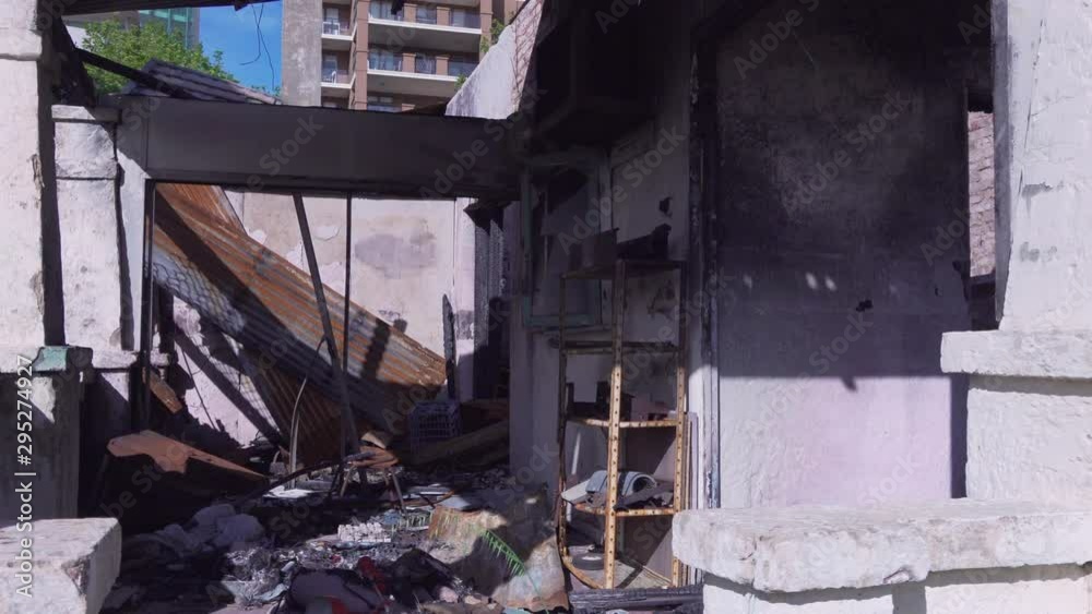 Pan from side of abandoned derelict house crossing verandah to front of ...