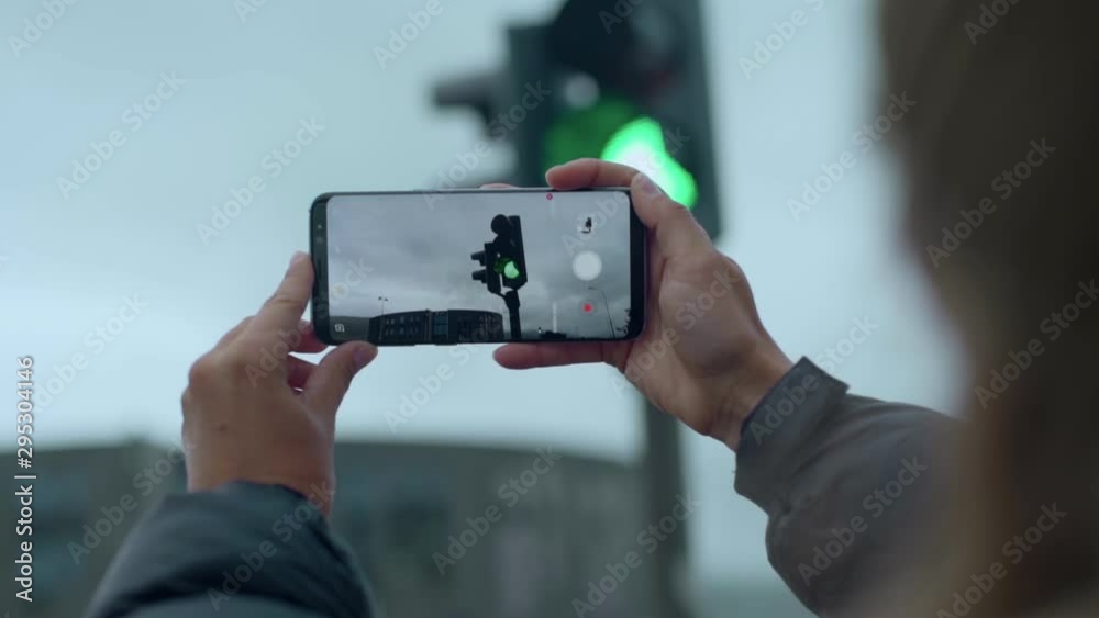 Behind shoulder shot of person holding smartphone with high resolution ...