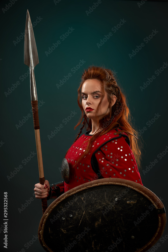 Powerful female fighter in armor keeping spear and shield Stock Photo ...