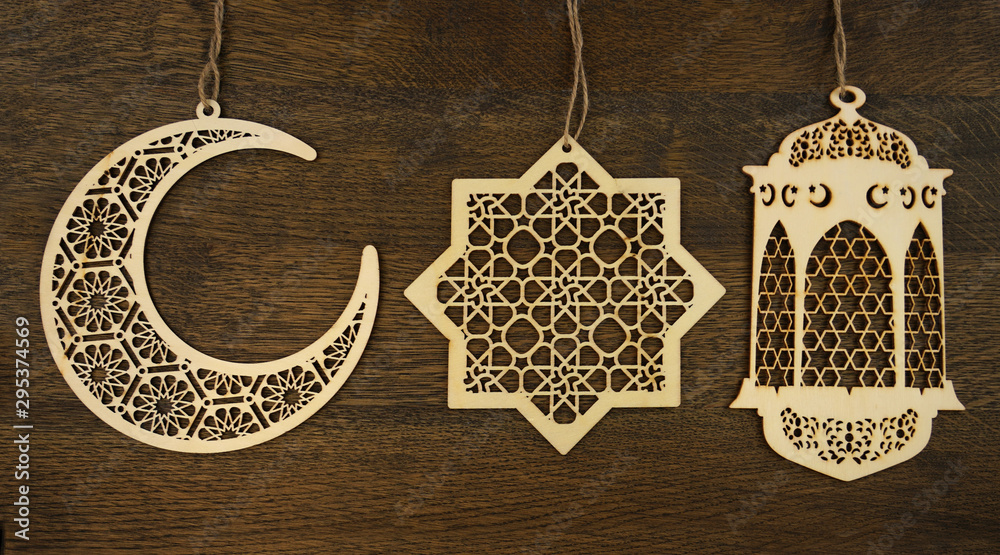 Islamic patterns. crescent moon with laser carved woods on brown wooden ...