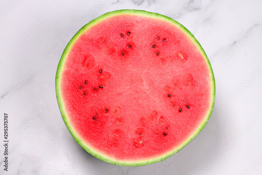 Cut slice of watermelon inside view isolated on white marble background ...