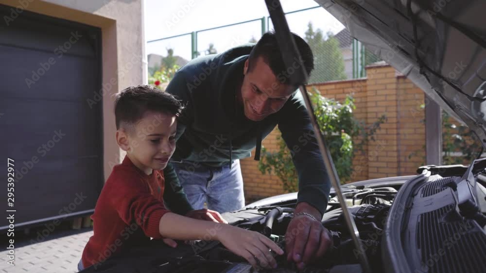 The father and son repair the car together Stock Video | Adobe Stock