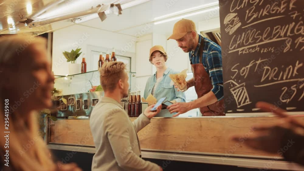Food Truck Employee Hands Out a Freshly Made Burger to a Happy Young ...
