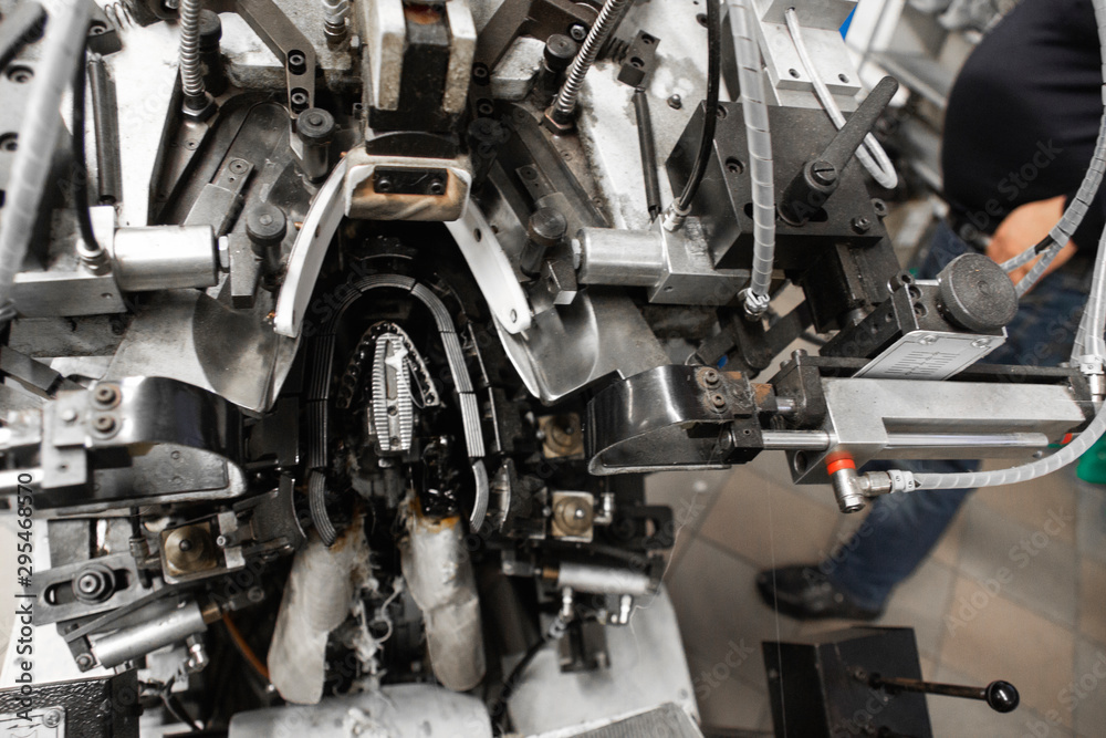 Man use special machine tool for making a shoes. The conveyor on a ...