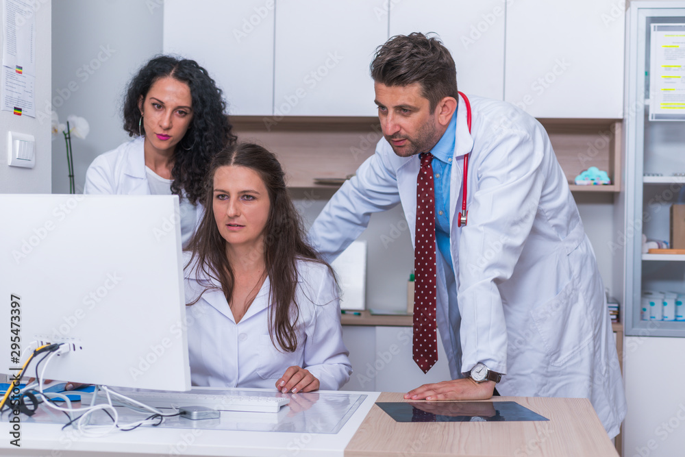 Two nurses ( female physicians ) and a male doctor standing next to a ...