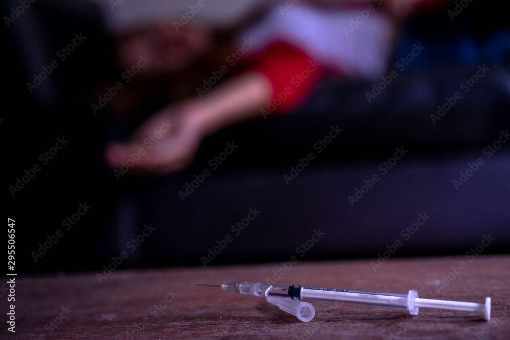 Close-up on the floor of the syringe with the drug. young woman ...