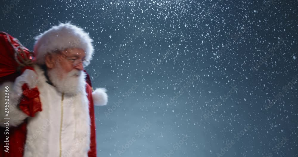 Santa Walking through snow, carrying a bag full of presents, then ...