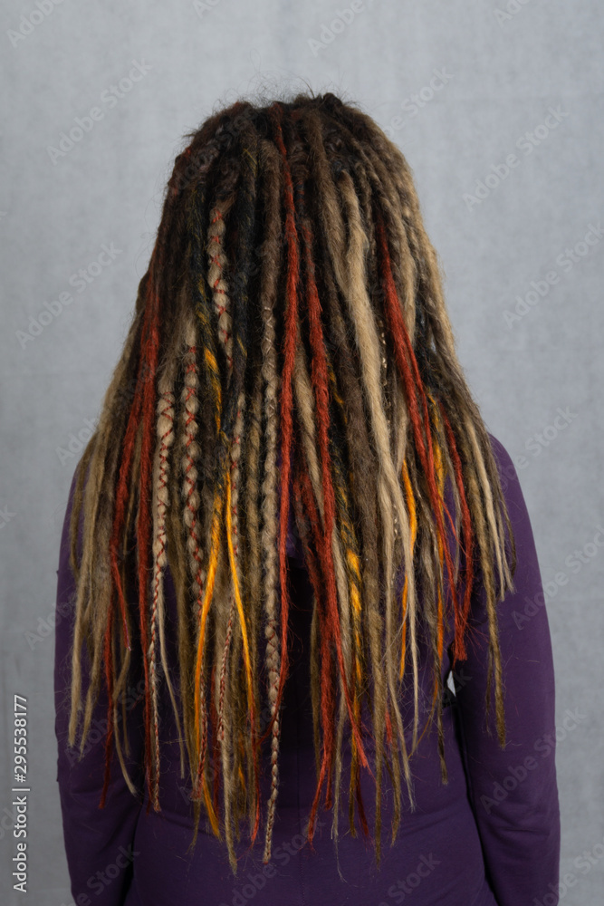 Woman with long dreadlocks shot from behind. Rear view of hairstyle ...