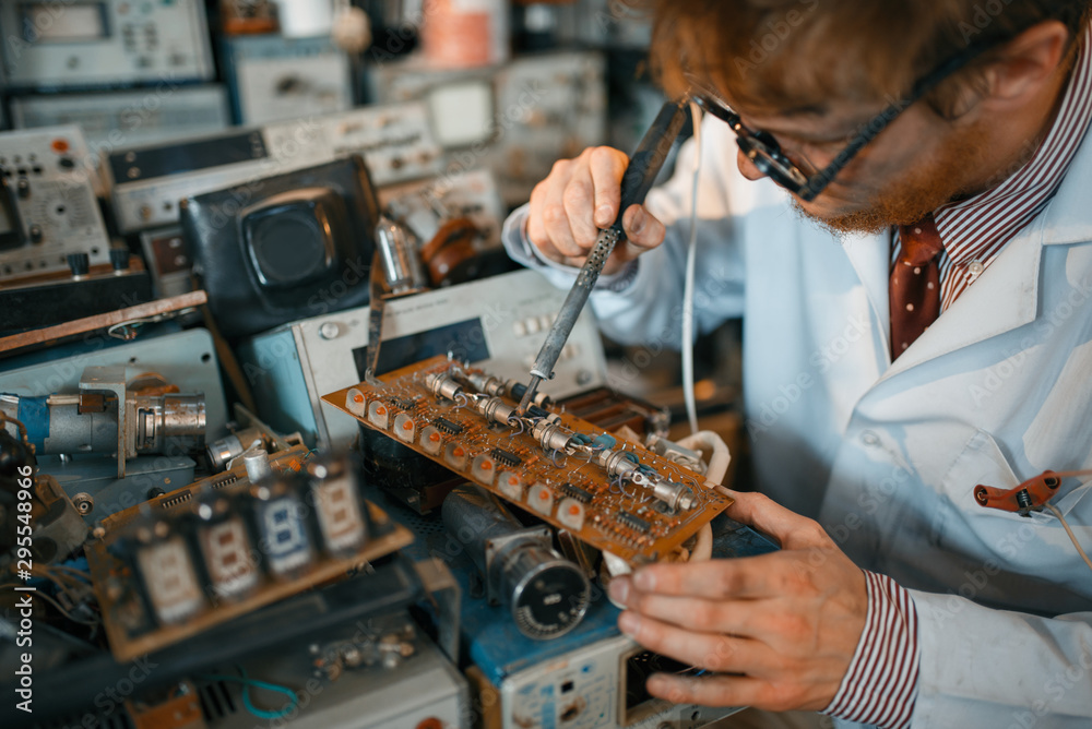 Strange scientist soldering chips, test in lab Stock Photo | Adobe Stock