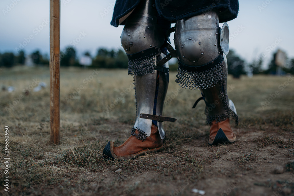Medieval knight legs in metal armor, back view Stock Photo | Adobe Stock