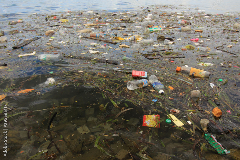 Plastic pollution in water. Bottles, bags and other trash dumped in sea ...
