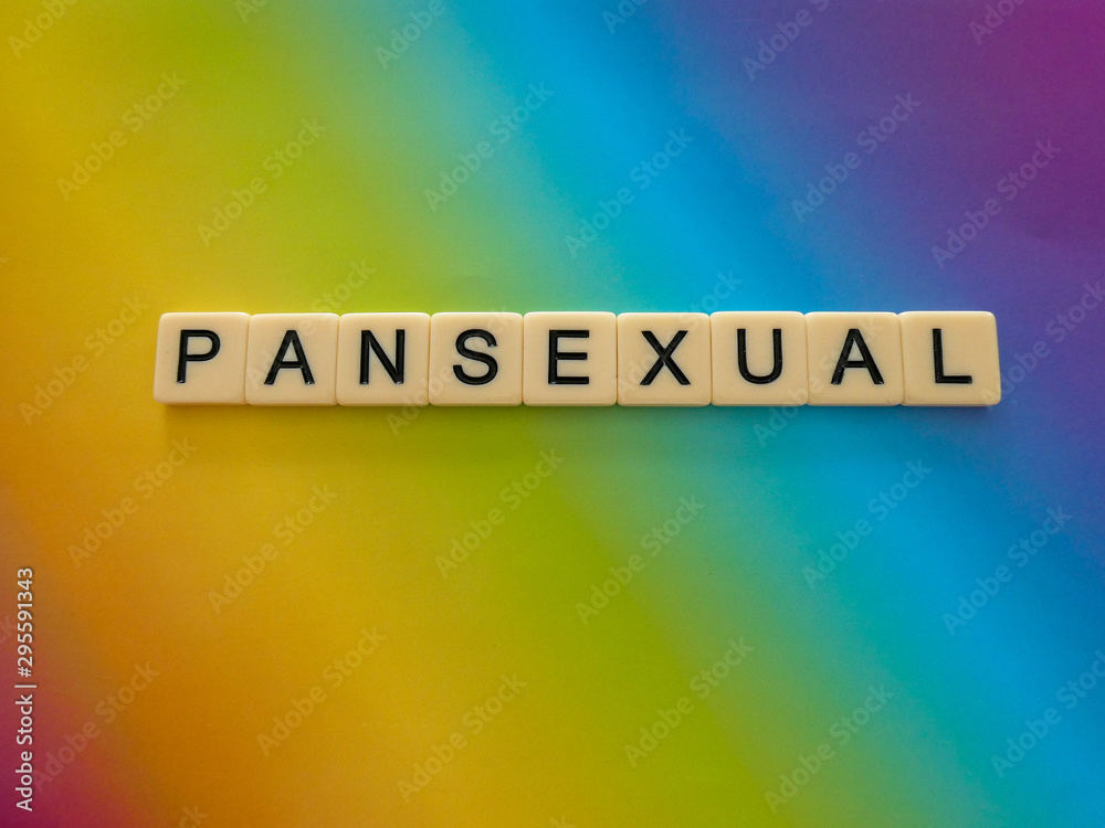 Bright rainbow colored background sign with the word "PANSEXUAL" in ...