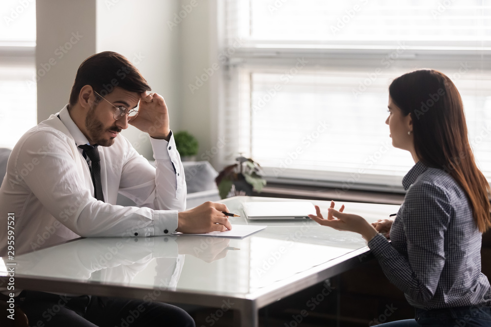 Confused male hr manager listening to female job applicant. Stock Photo ...