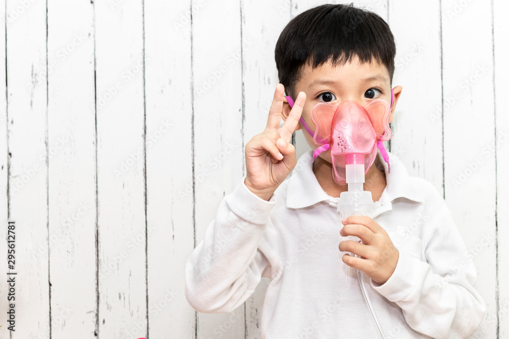 Asia boy using nebulizer and inhaler for the treatment. Little child ...