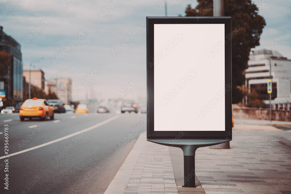 Mock-up of an empty information poster near a highway; a blank vertical ...