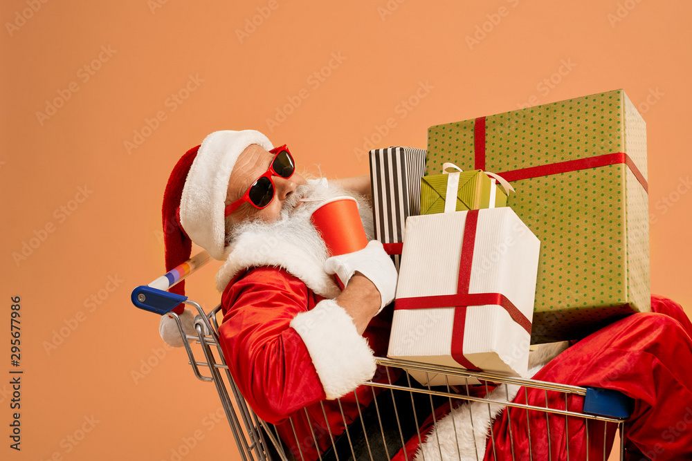 Santa Claus inside shopping cart with lots of gift boxes Stock Photo ...