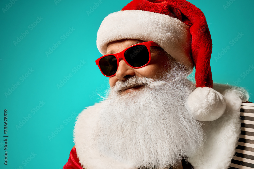 Santa Claus in red sunglasses smiling and posing in studio Stock Photo ...