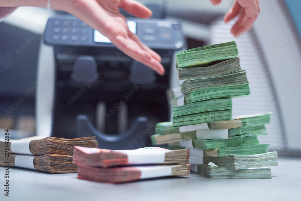 Bank employees sorting and counting money inside bank vault. Stock ...