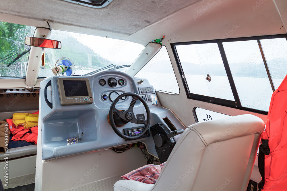 Cabin of a motor boat with an inside view with a steering wheel seat ...