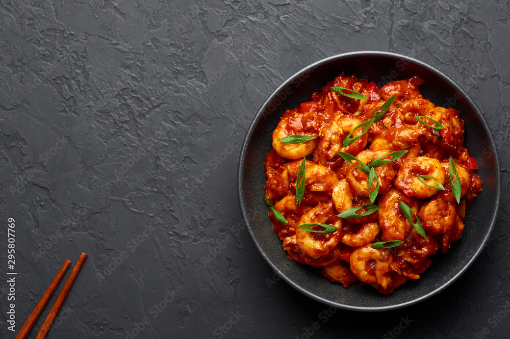 Schezwan Prawns in black bowl at dark slate background. Schezwan Prawns ...