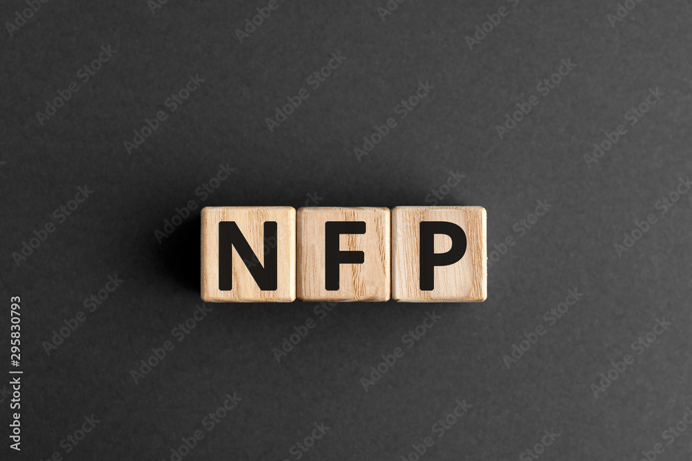 NFP - acronym from wooden blocks with letters, abbreviation NFP Nonfarm ...