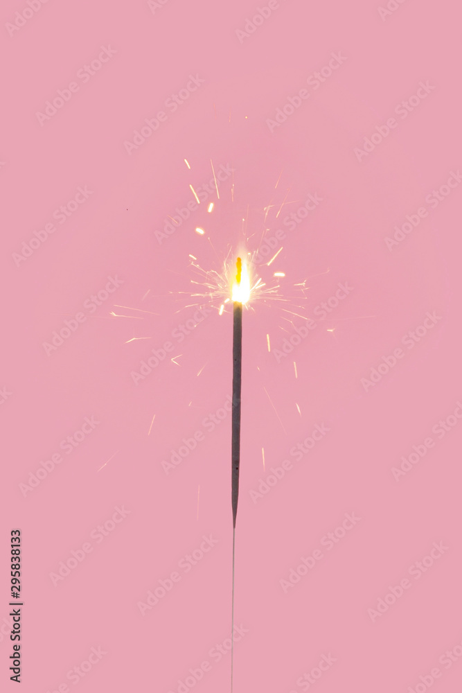 Sparklers light up on pastel pink background Stock Photo | Adobe Stock