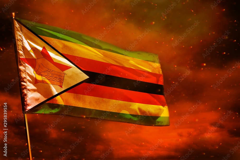 Fluttering Zimbabwe flag on crimson red sky with smoke pillars ...