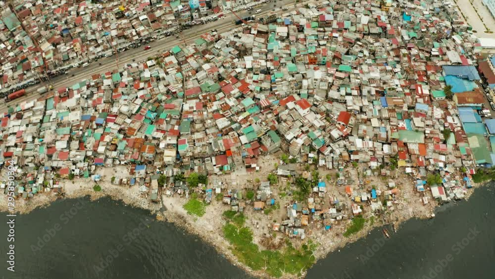 Slums with shacks of local residents and the river bank littered with ...