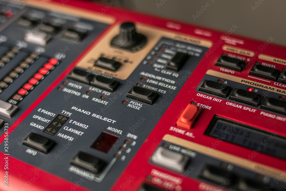 Button panel of a classic red stage synthesizer, with various controls ...