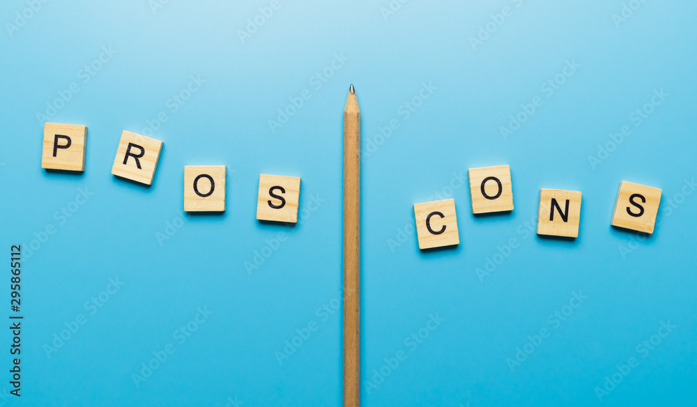 "Pros and Cons" word in the wooden block on blue background separated ...