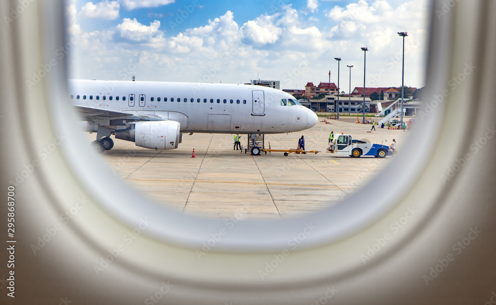View trough window of aircraft at Airplane standing on International ...