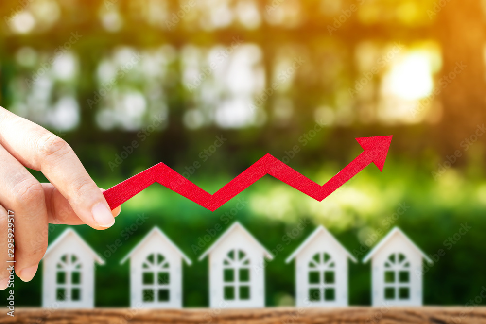 Woman hand hold a red arrow graph with growing value on many white ...