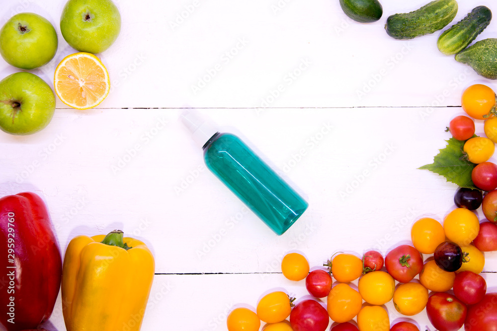Care cosmetics from natural fruits and vegetables. Blue bottle of ...