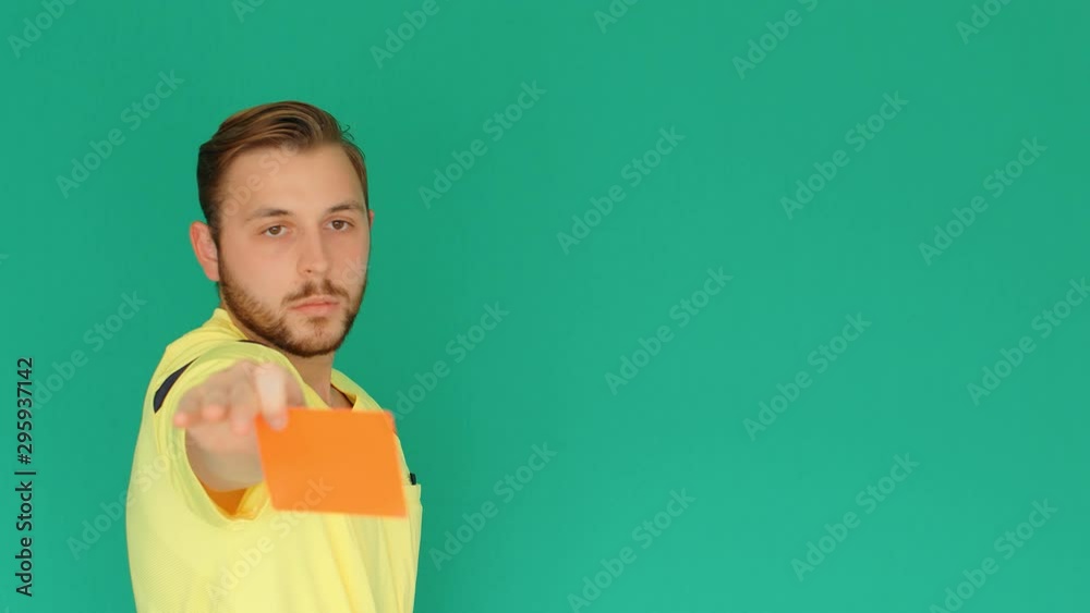 Football Soccer referee on green screen shows penalty yellow and red ...