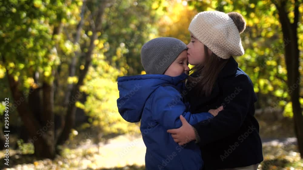 Close-up portrait of cute smiling little brother and sweet older sister ...